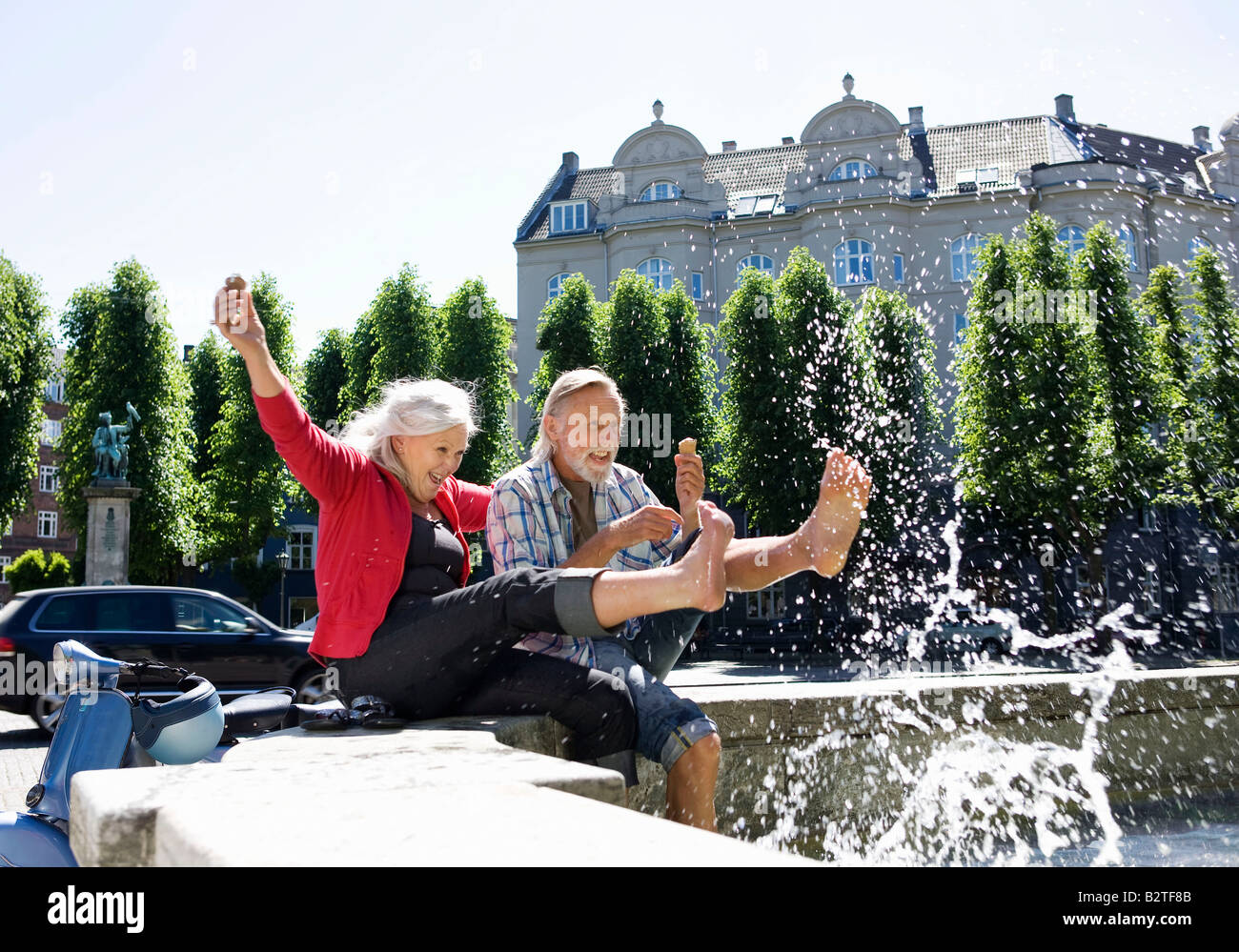 Couple splashing water Stock Photo - Alamy