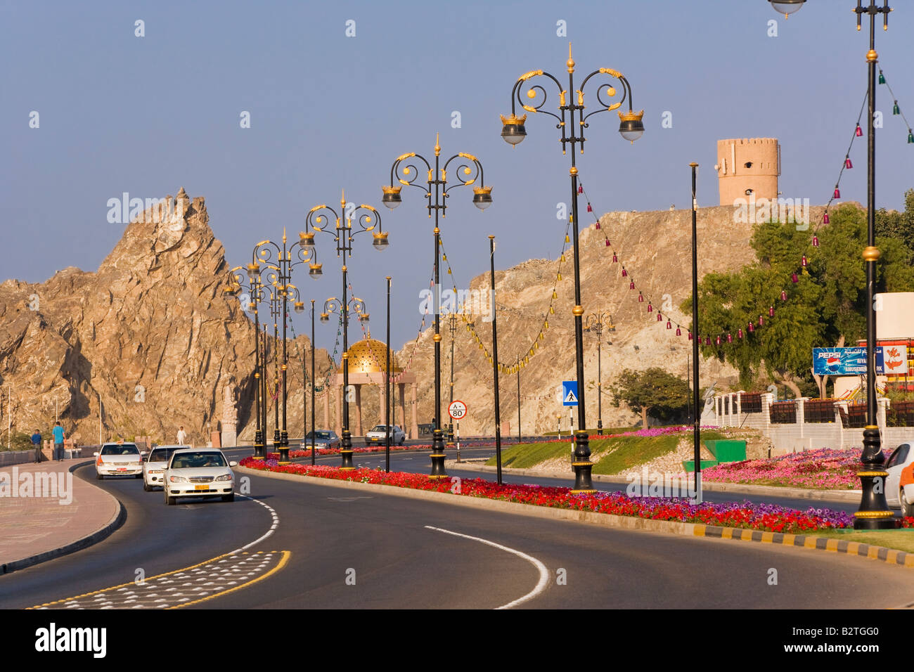 Middle East, Oman, Muscat, road with ornate lamposts leading along the ...