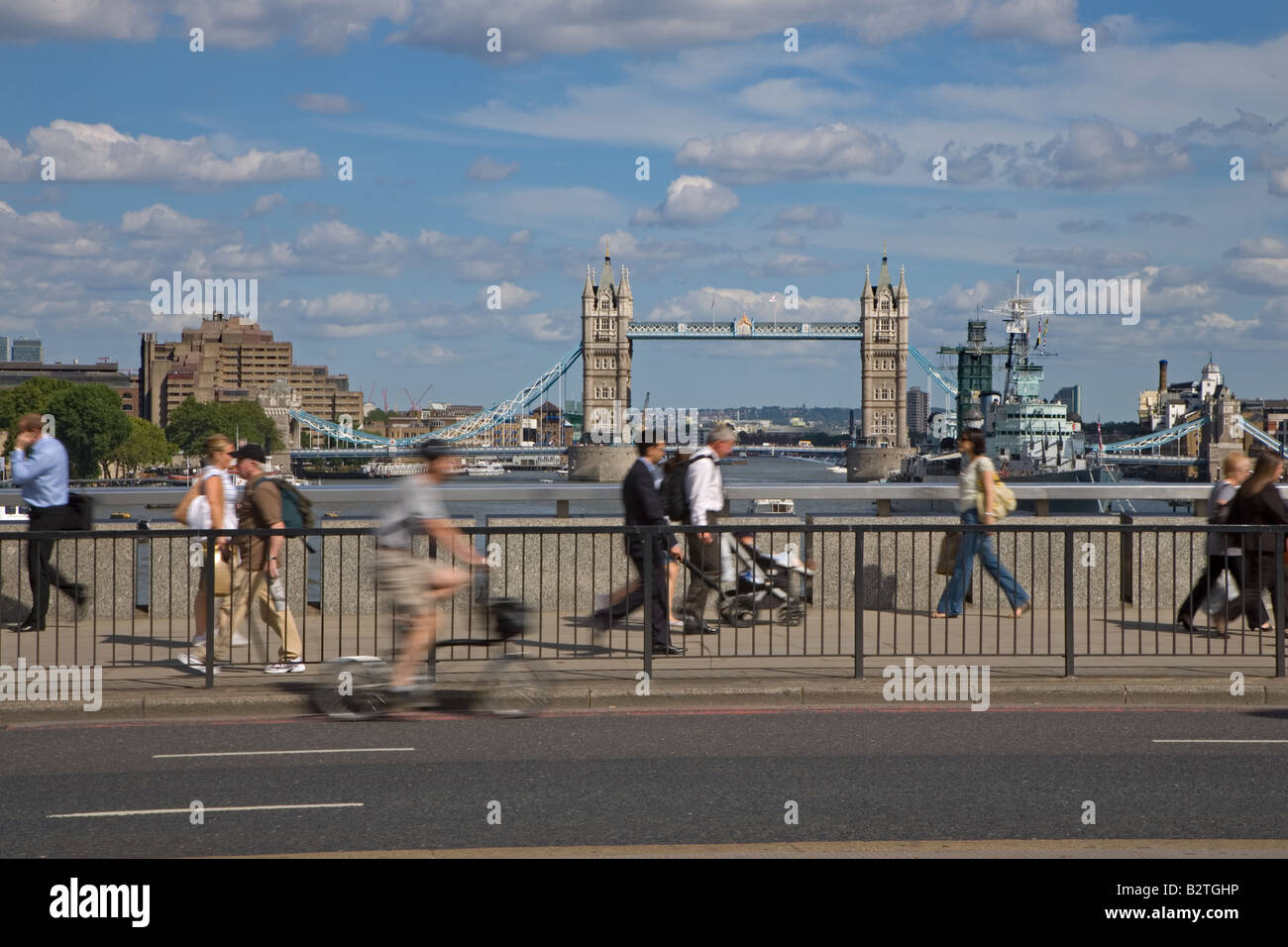 people walking on London Bridge with Tower bridge in the background ...