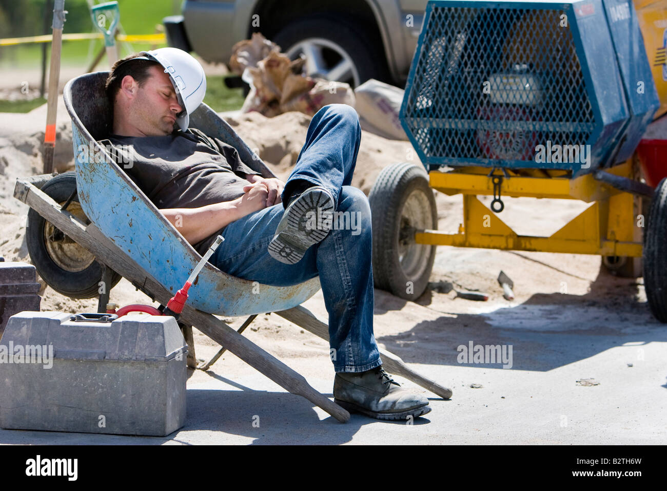 A man sleep in a wheelbarrow Stock Photo - Alamy