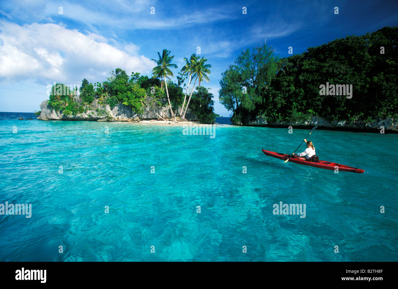 Ocean kayak with beach and small island in background Palau Micronesia ...