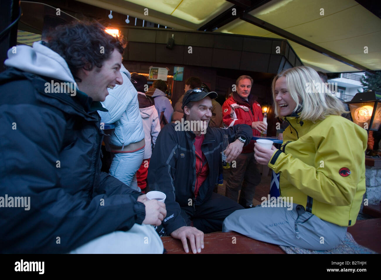Group of young people enjoying an Apres Ski party on terrace of ...