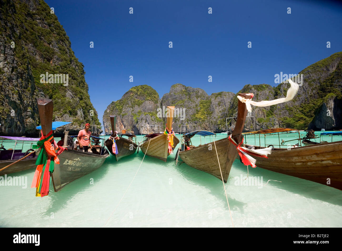Boats anchoring in the Maya Bay, a beautiful scenic lagoon, famous for ...