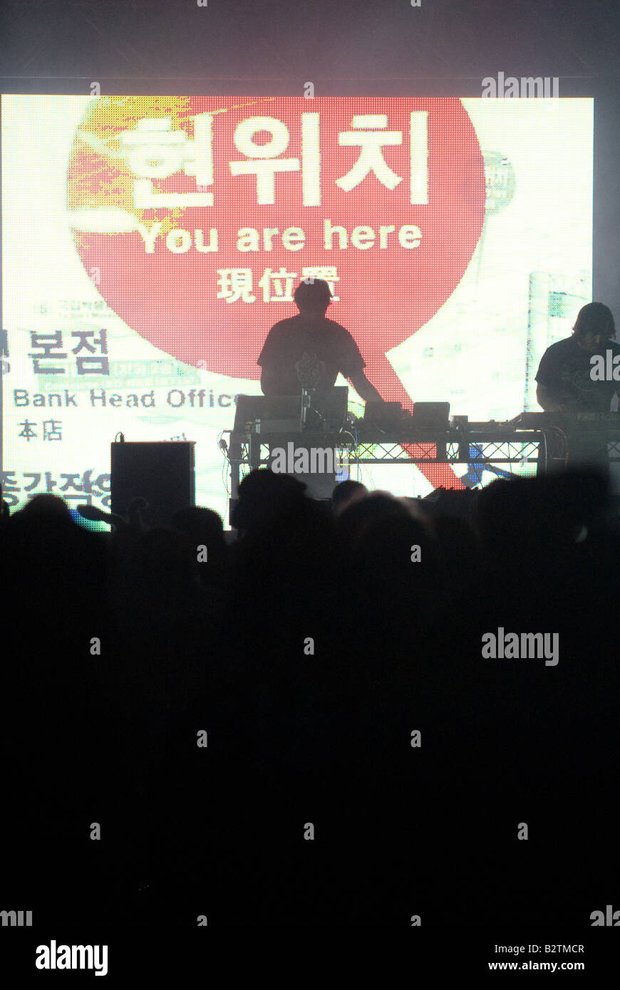 electronic musicians perform on stage with laptop computers at music ...