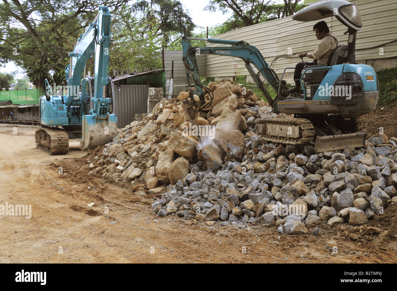 Digger and mini digger at building construction site in Singapore Stock ...