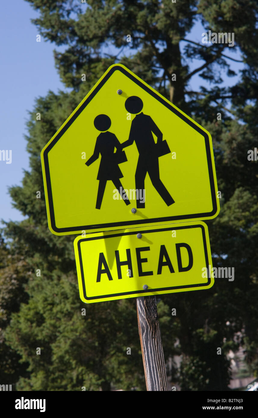 Yellow road sign people crossing Ahead WA USA US Stock Photo - Alamy