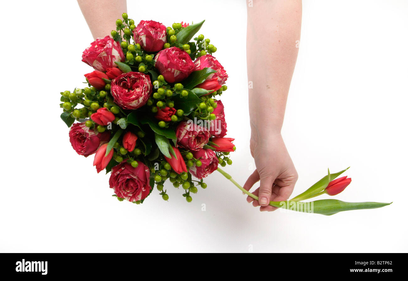 Flower arrangement step by step. Roses, tulips, greenery Stock Photo ...
