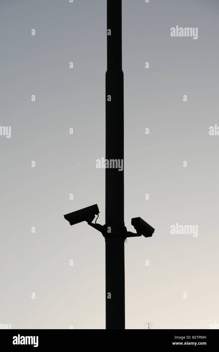 two cctv cameras silhouette on high pole outdoors Stock Photo - Alamy