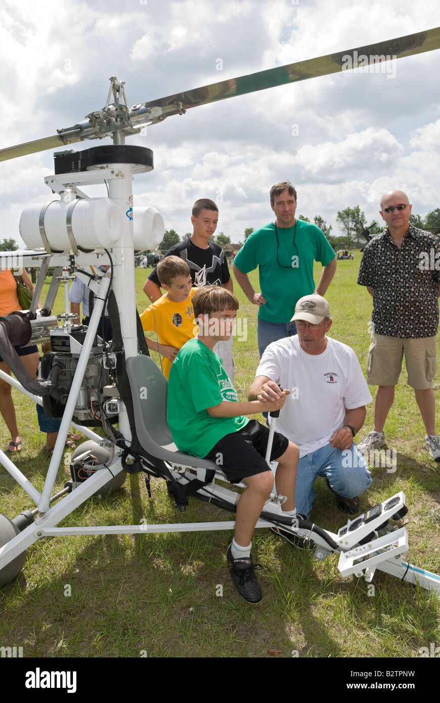 man demonstrates to child how to learn to fly helicopter via ...