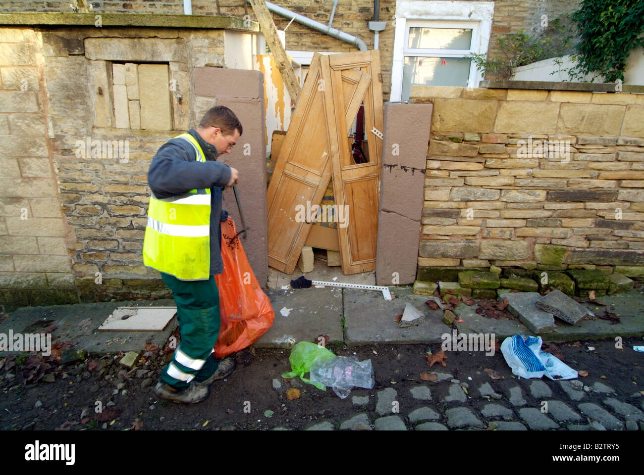Man collecting rubbish from back streets Stock Photo - Alamy