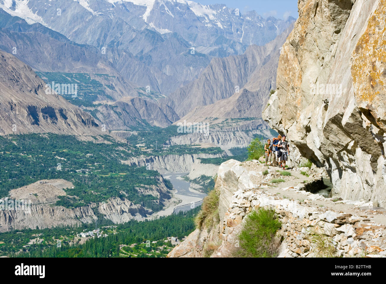 Hikers on a Precarious Path in the Mountains Above Karimabad in the ...