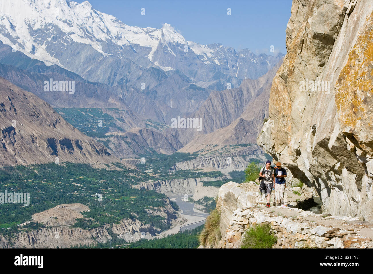 Hikers on a Precarious Path in the Mountains Above Karimabad in the ...