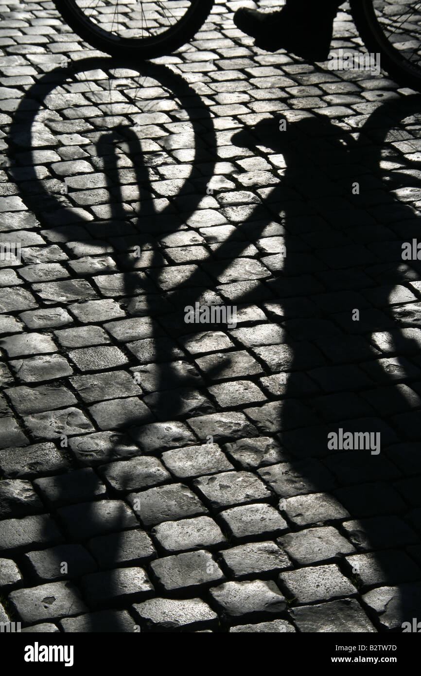 bike shadow on cobbled street road in city town Stock Photo - Alamy
