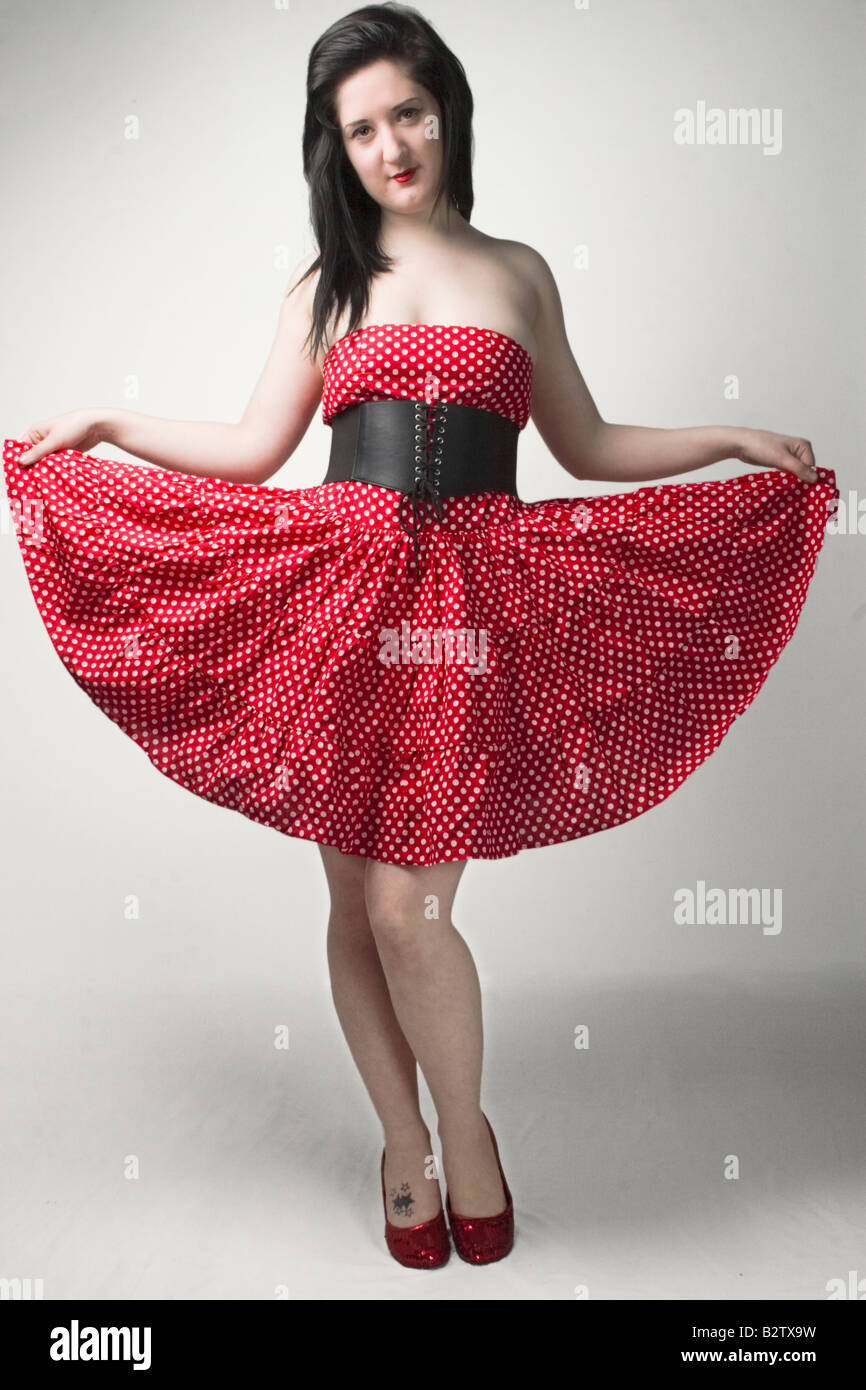 Burlesque portrait of a young brunette woman wearing a vintage red ...