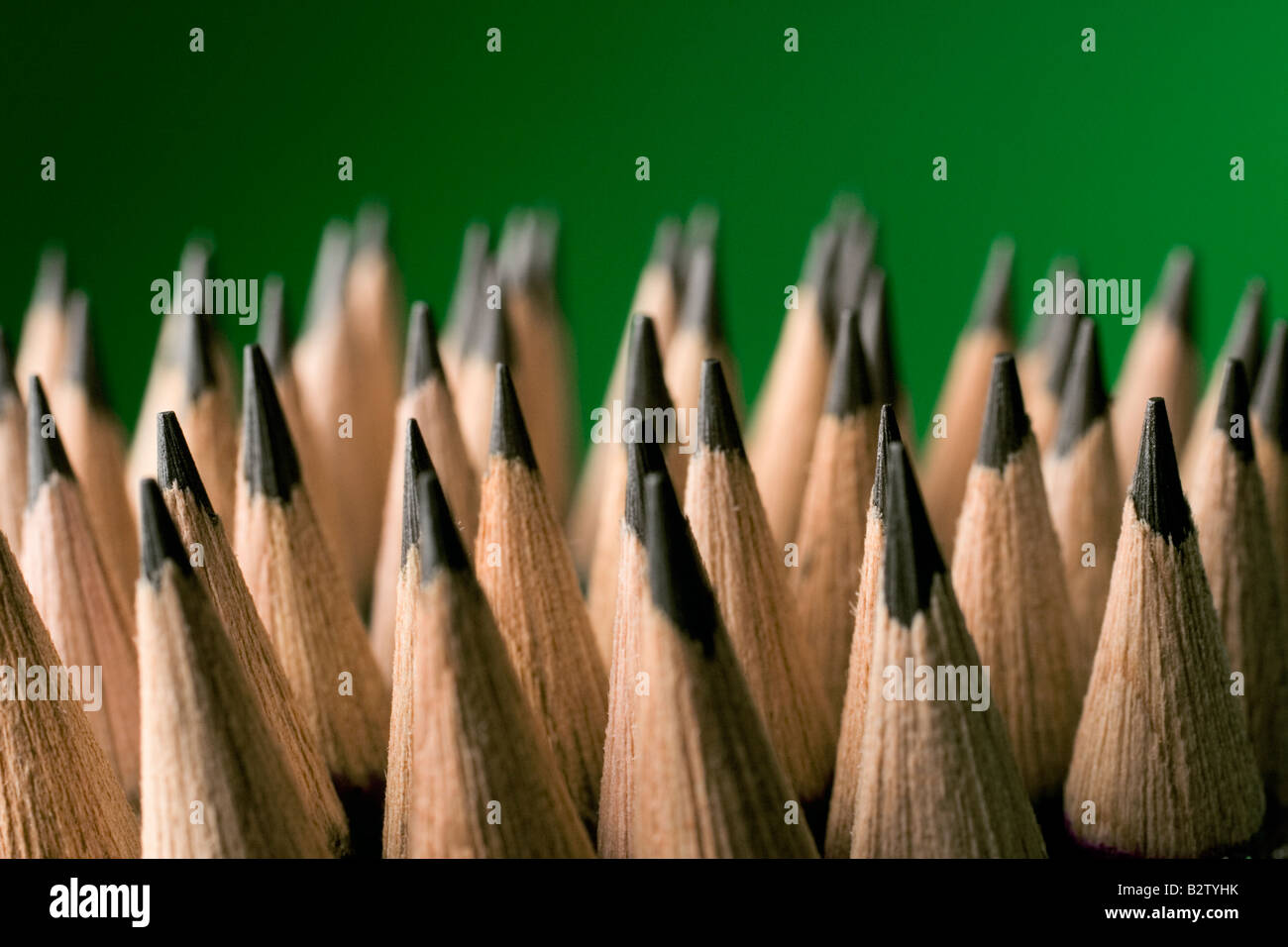 Close-up of a group of lead pencils against a green background Stock ...