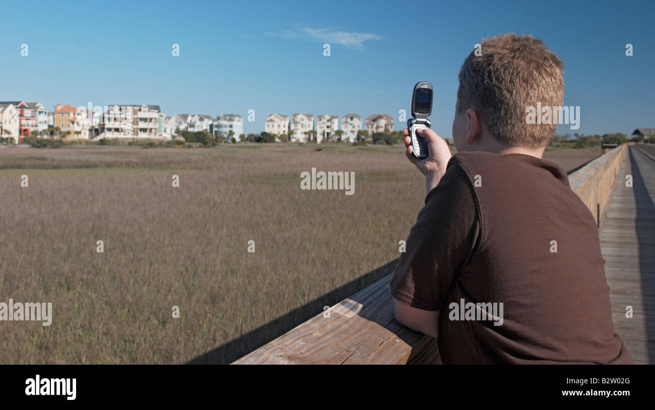 A Young boy taking photos with a cell phone Stock Photo - Alamy