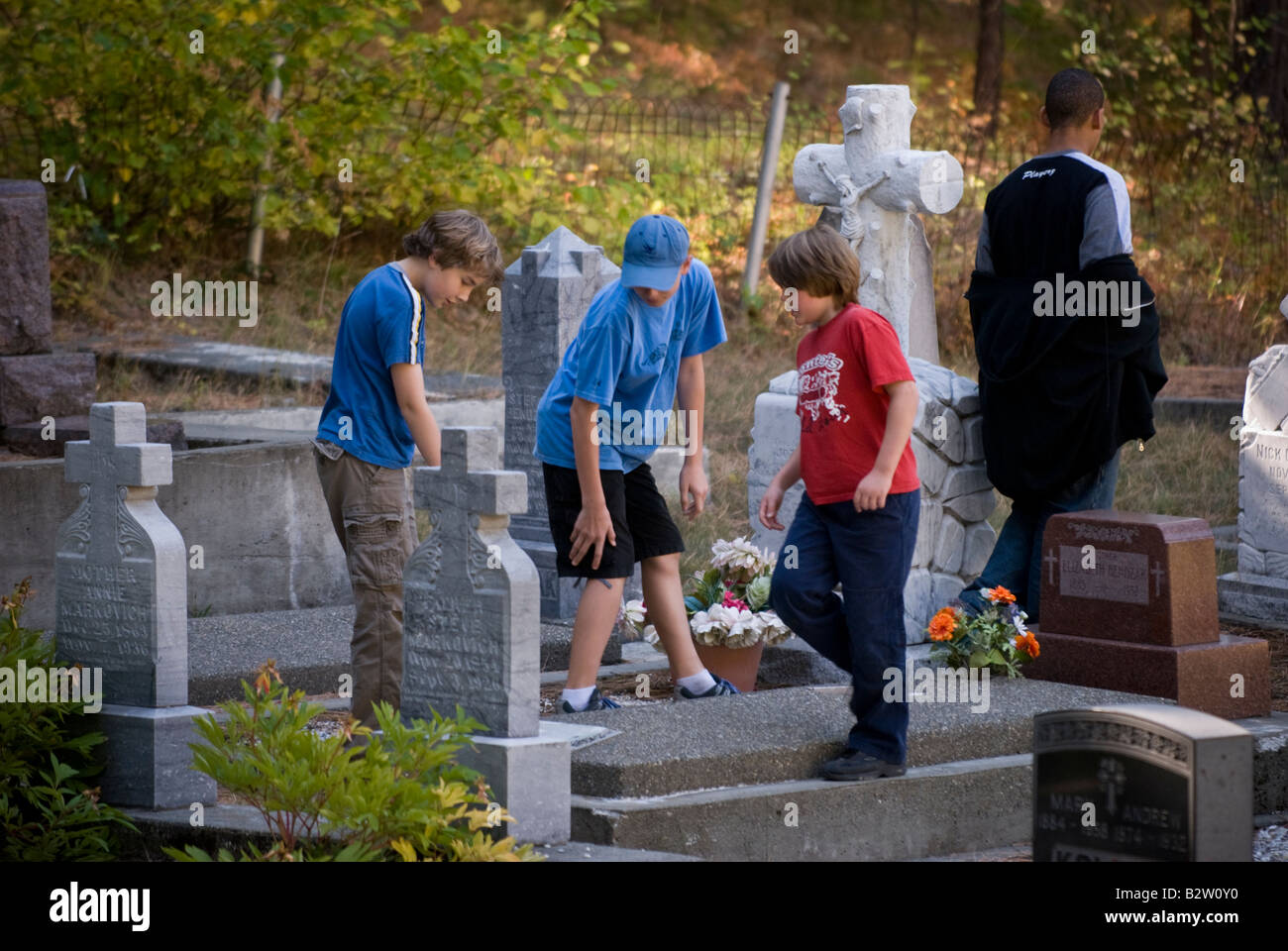 Teenage boys explore the local cemetery in Wenatchee, Washington Stock ...