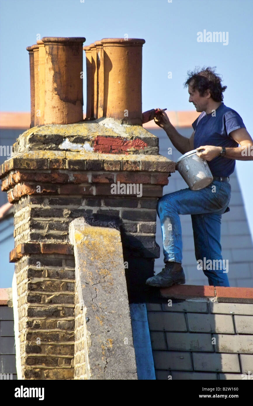 painting chimney top of domestic house Stock Photo - Alamy