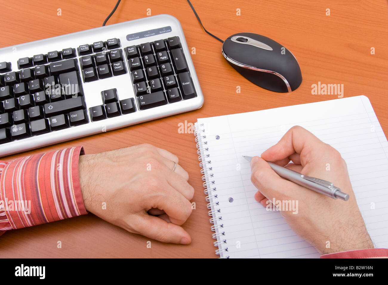 Business man writing in a notebook Stock Photo - Alamy