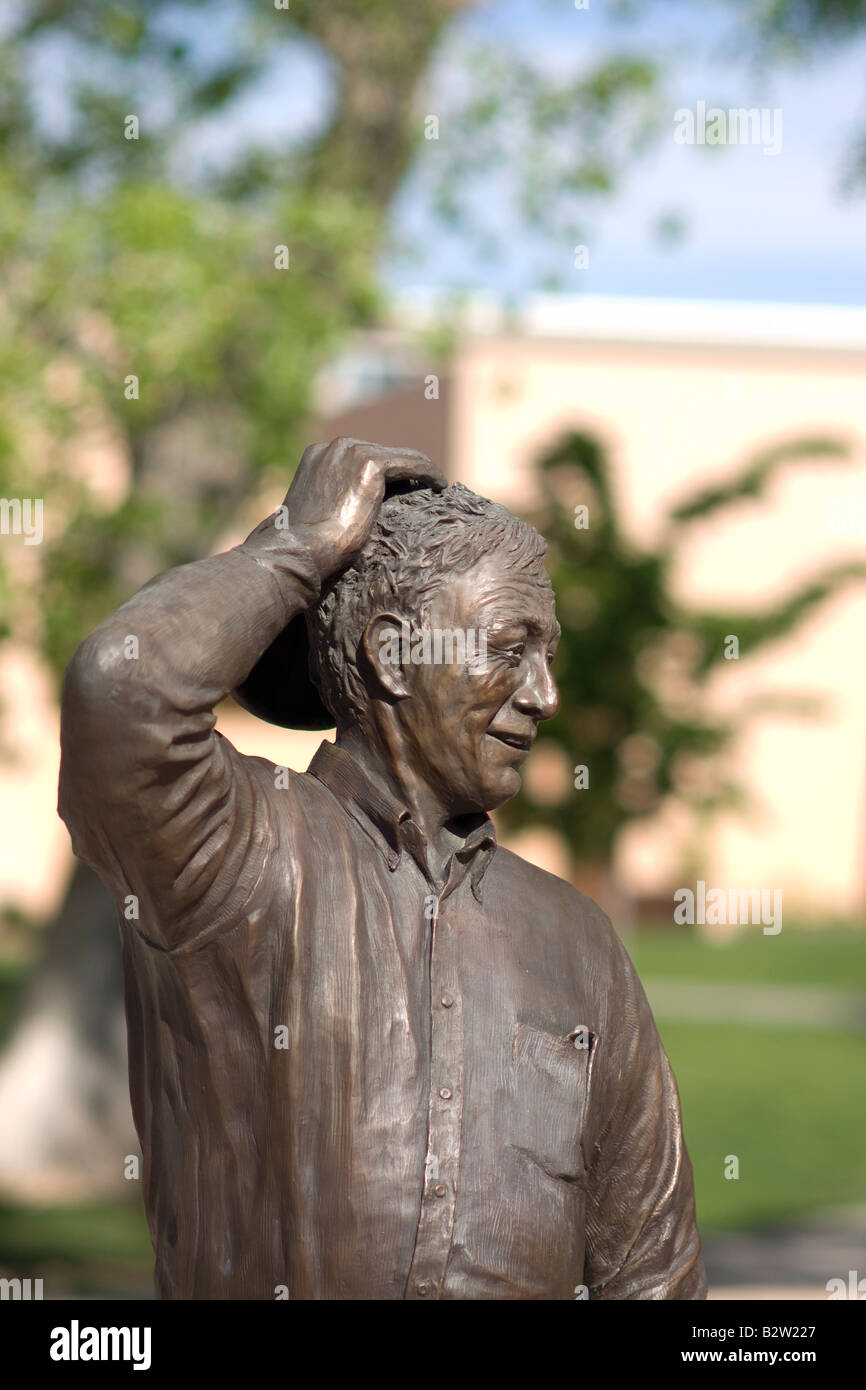 A bronze statue depicting a confused man looking at something Stock ...