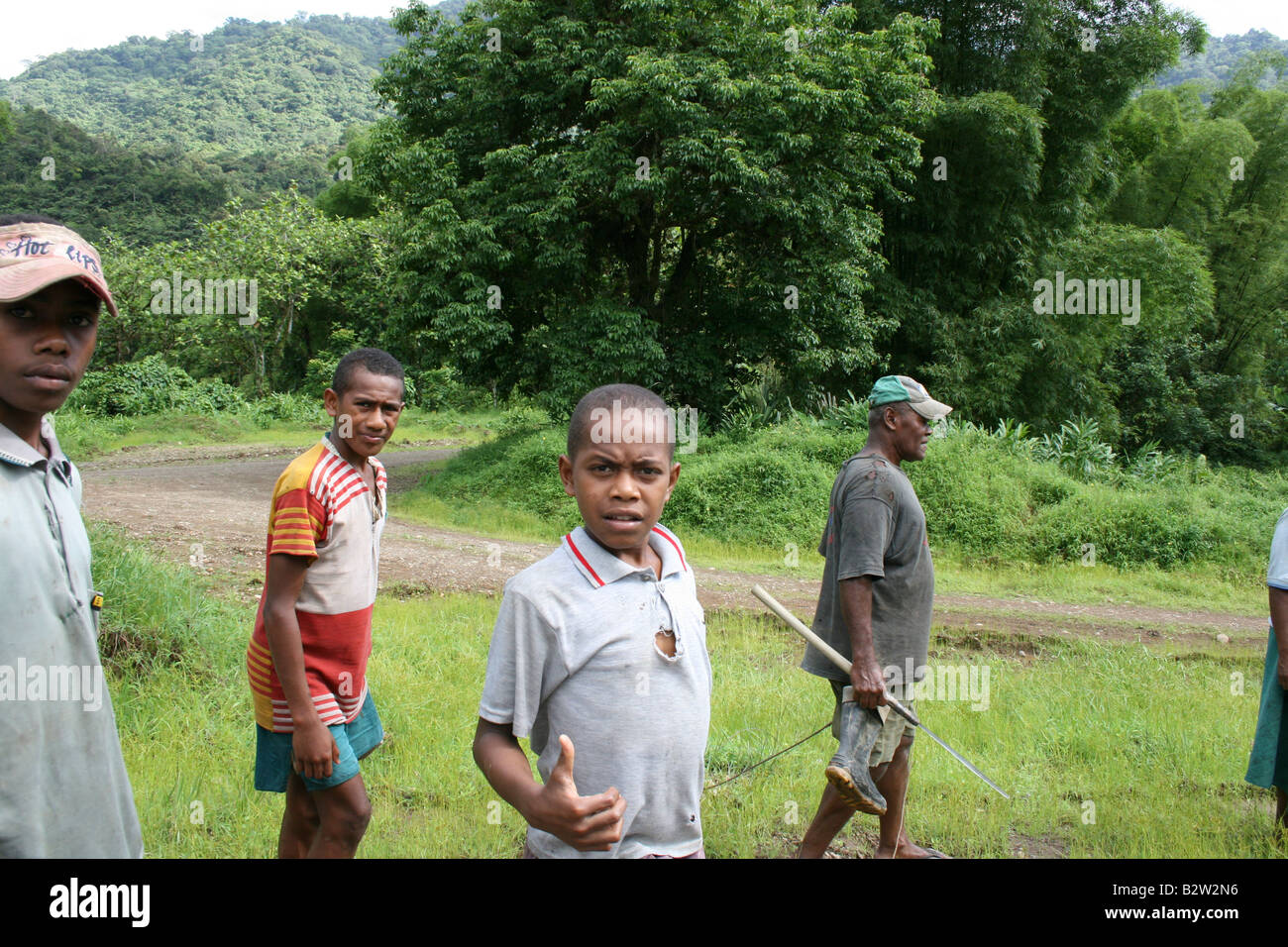Fijian villagers walking Stock Photo - Alamy