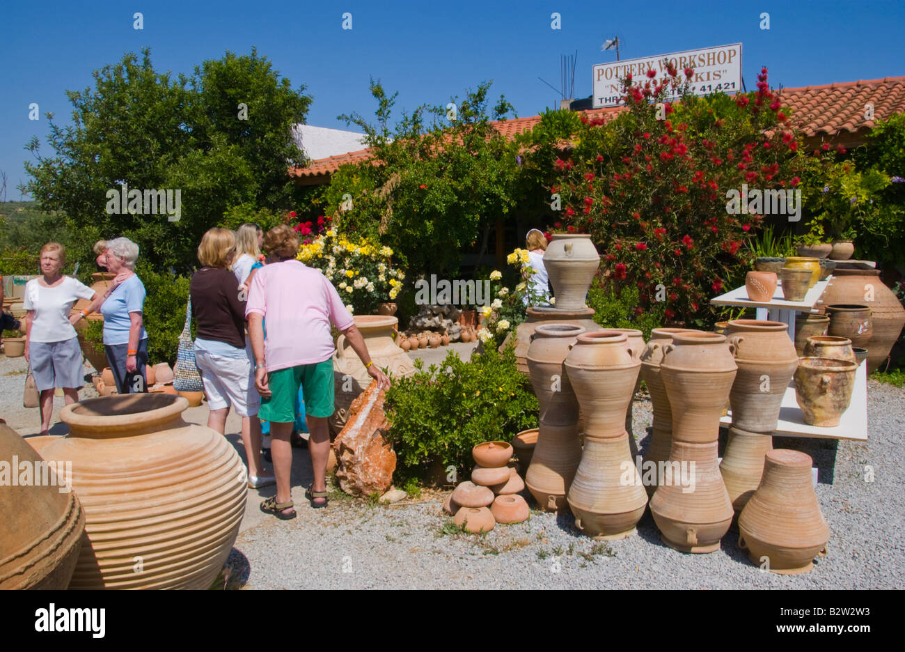 Women tourist browse pots for sale at pottery in Thrapsano on the Greek ...