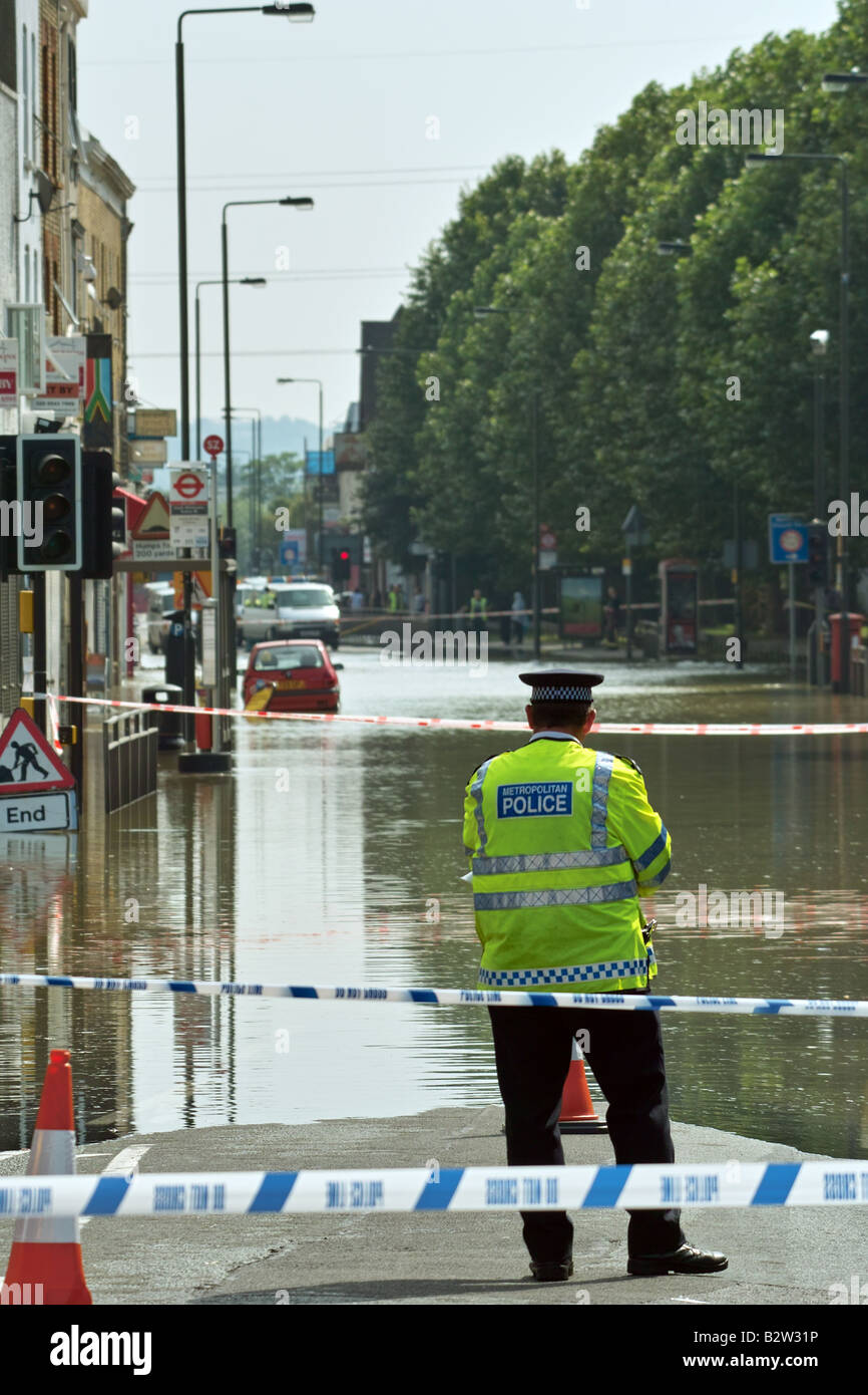 High Street Flood Barrier with Police officer Stock Photo - Alamy