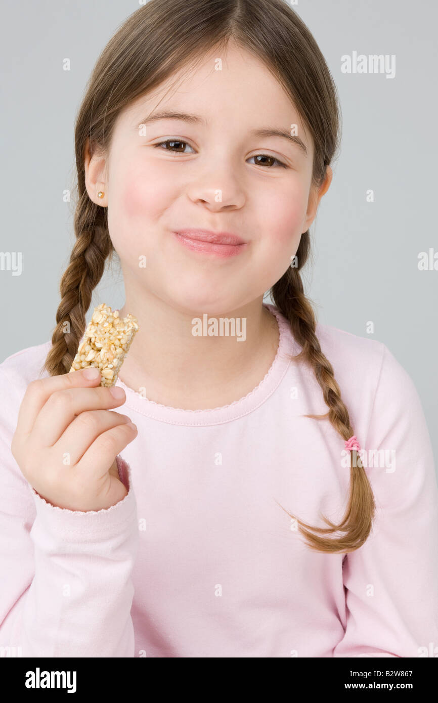 Girl eating cereal bar hi-res stock photography and images - Alamy