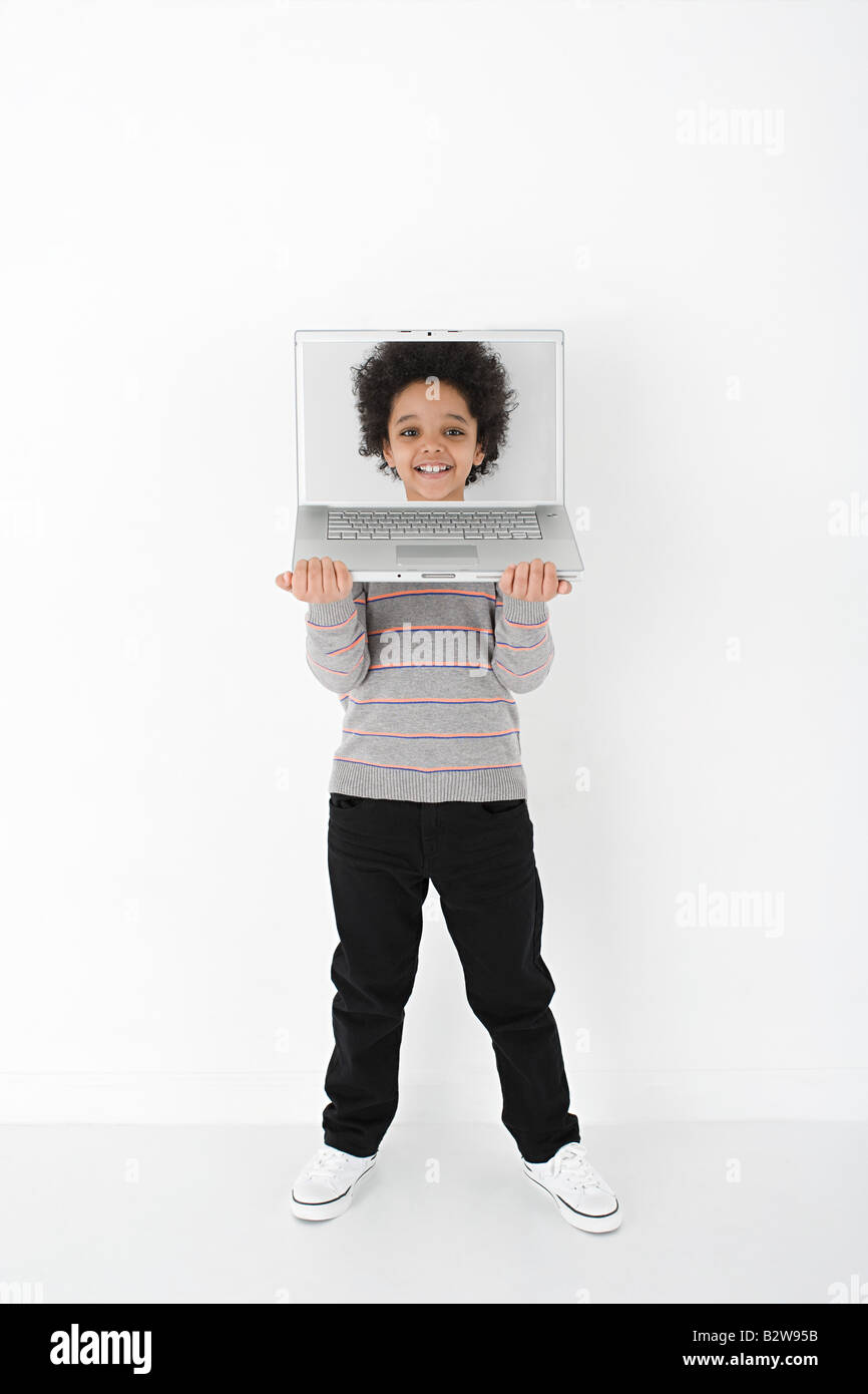 Boy with face on laptop Stock Photo - Alamy