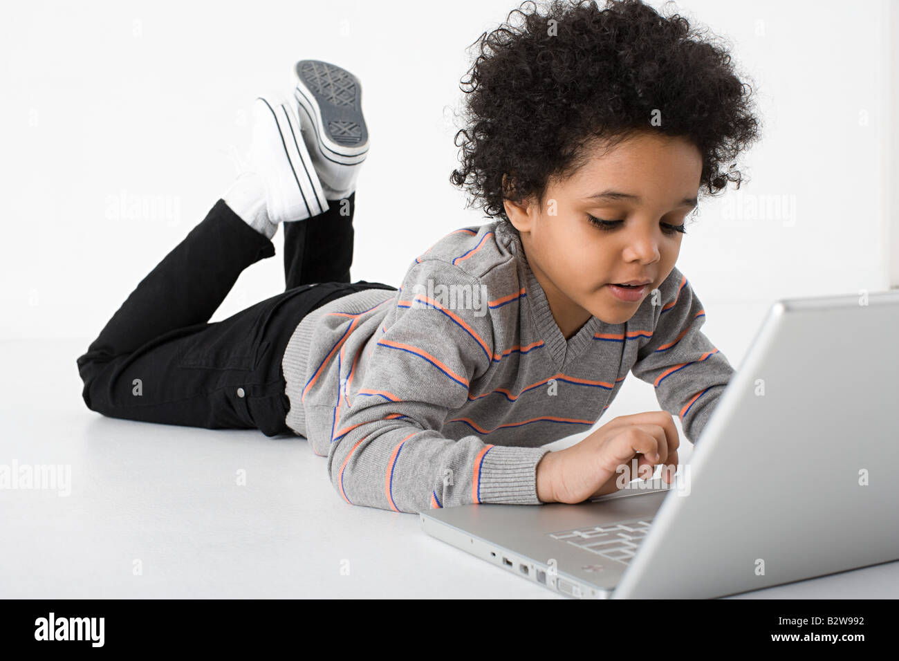 Boy using laptop Stock Photo - Alamy