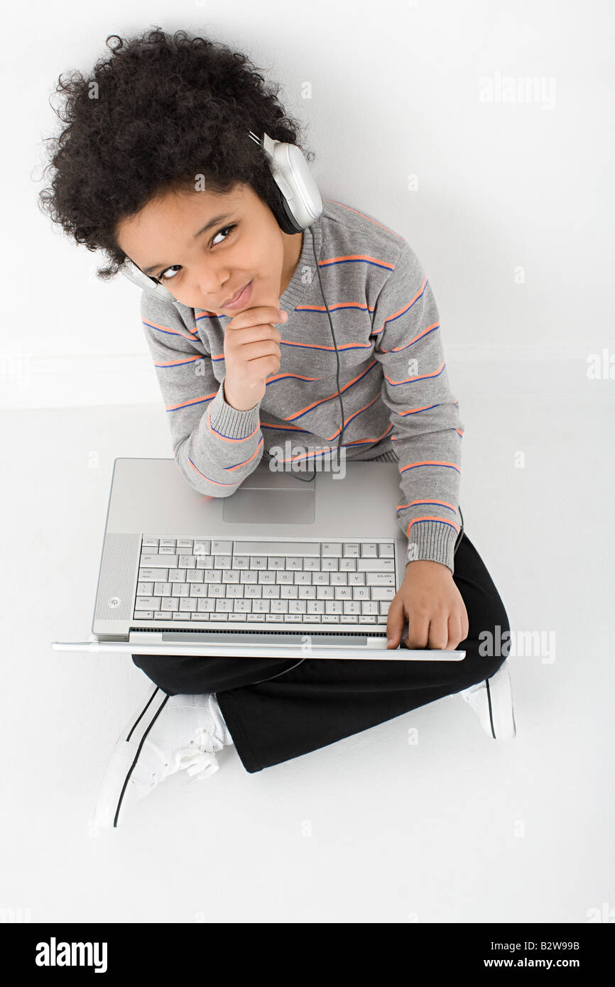 Boy listening to music on laptop Stock Photo - Alamy