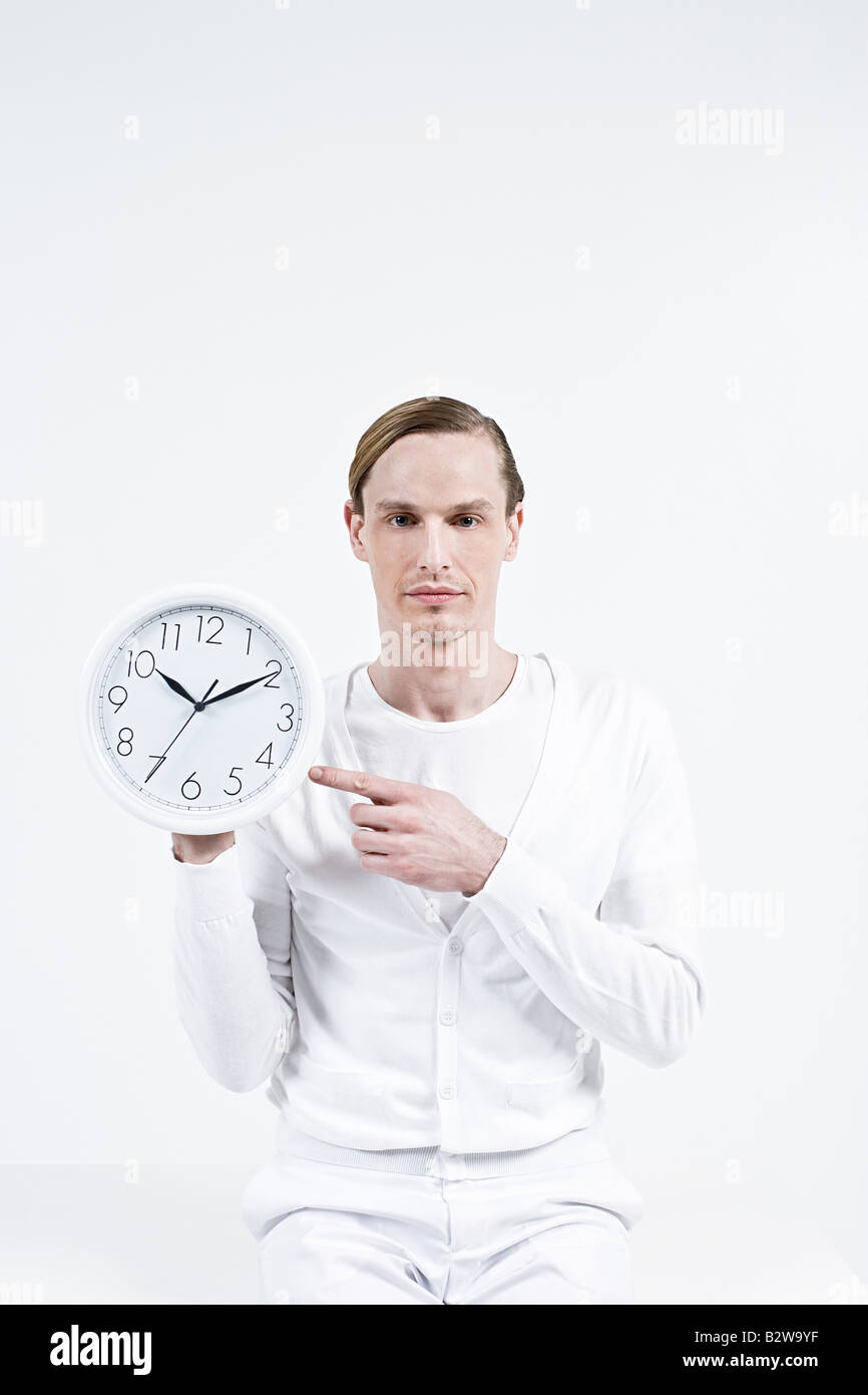A man holding a clock Stock Photo - Alamy