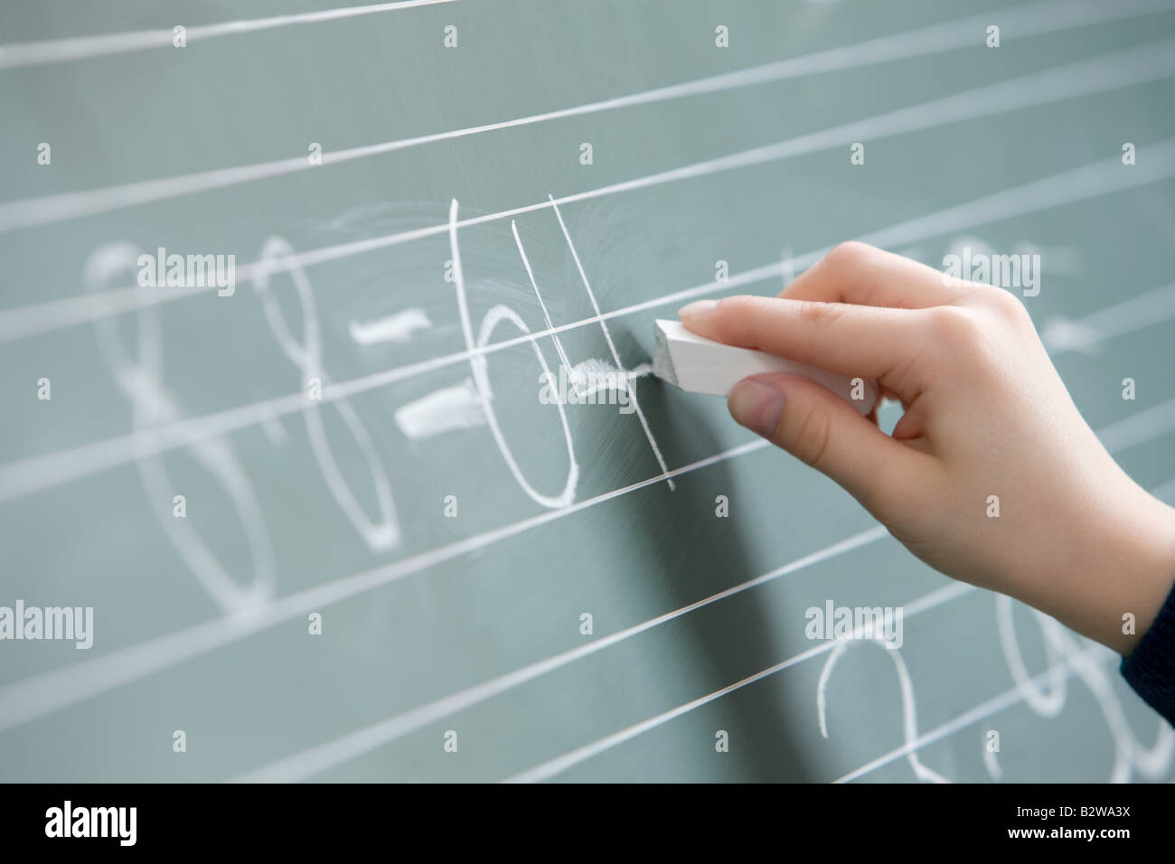 Child writing on blackboard Stock Photo - Alamy