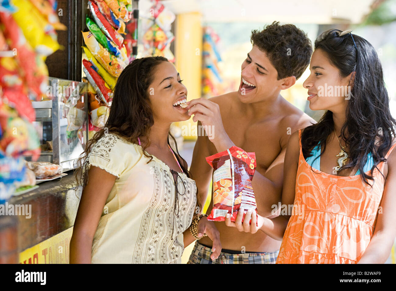 Friends eating crisps Stock Photo - Alamy