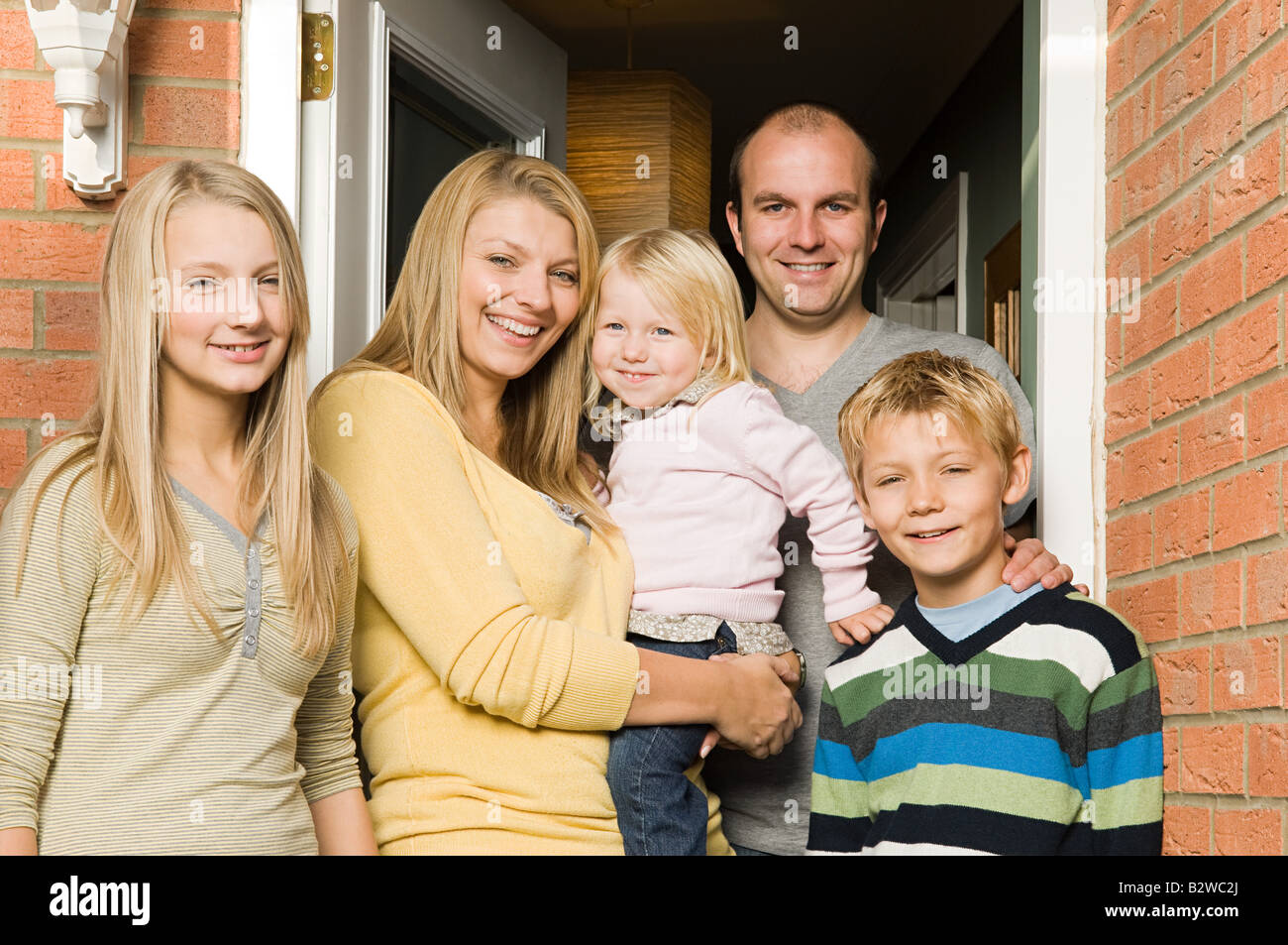 Family outside house Stock Photo - Alamy