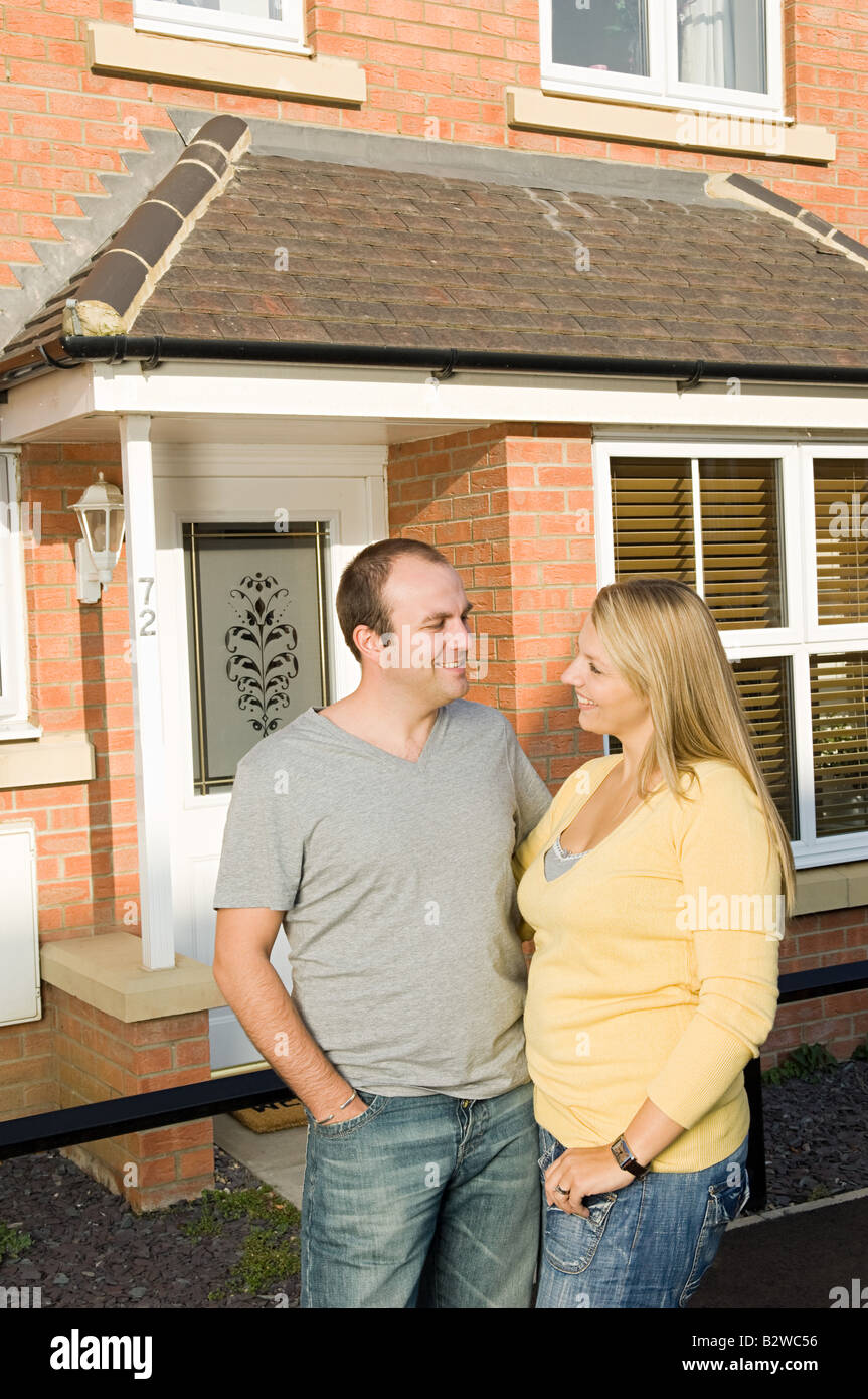 Couple outside house Stock Photo - Alamy