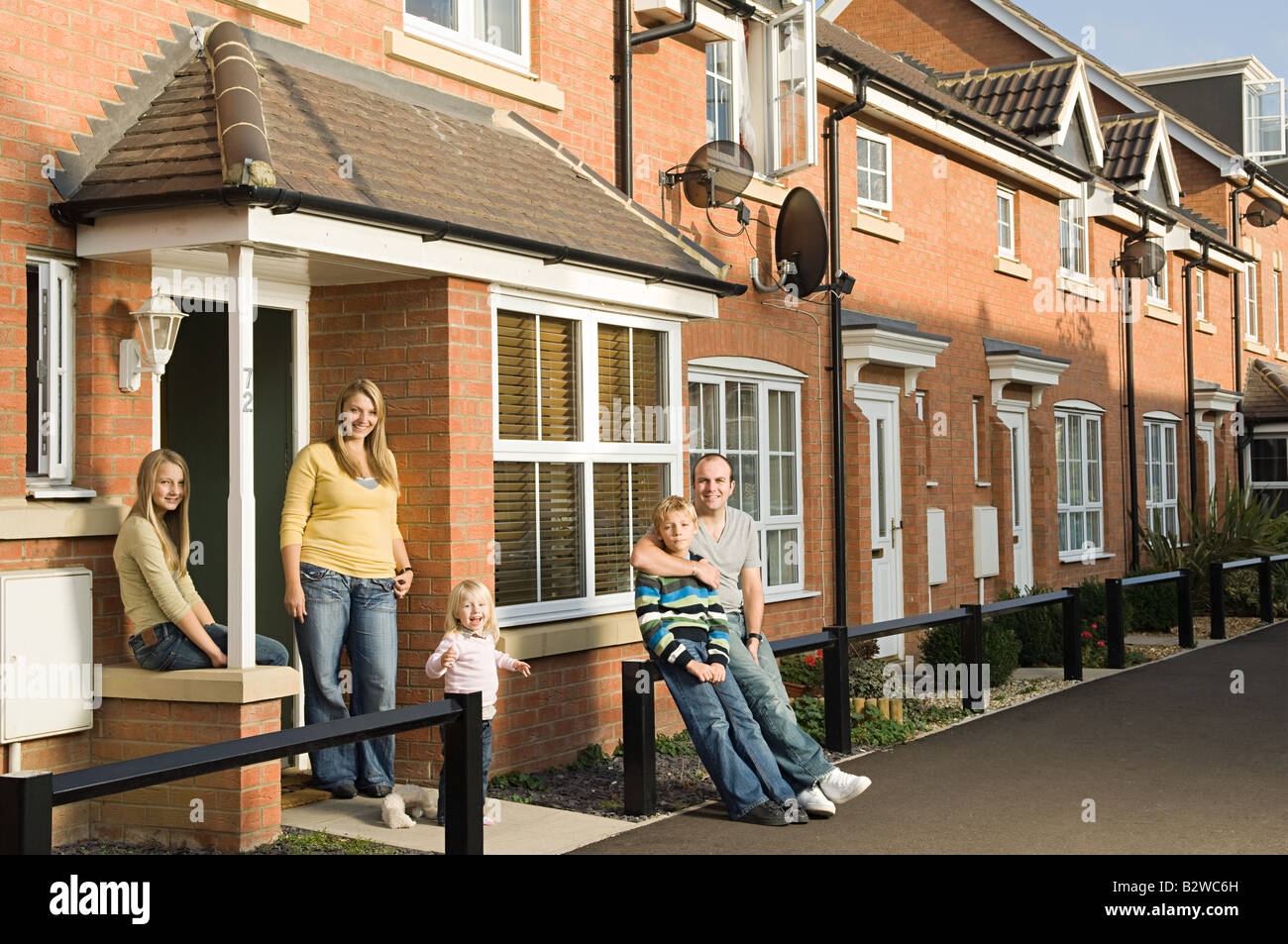 Family outside house Stock Photo - Alamy