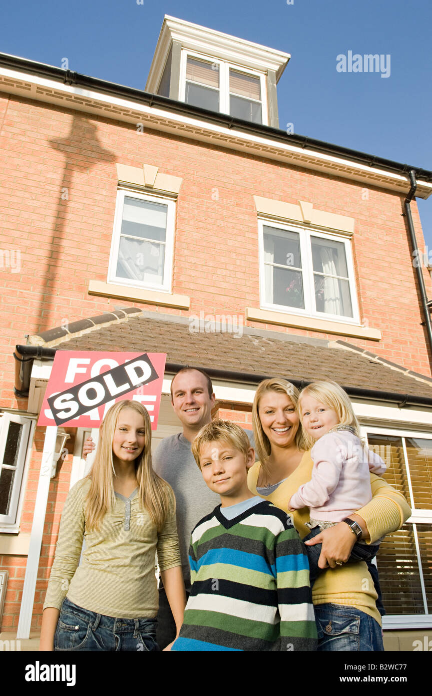 Family outside new house Stock Photo - Alamy