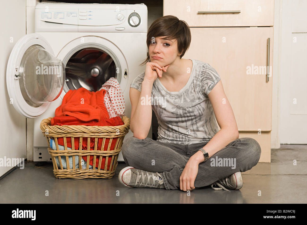 Young woman by washing machine Stock Photo - Alamy