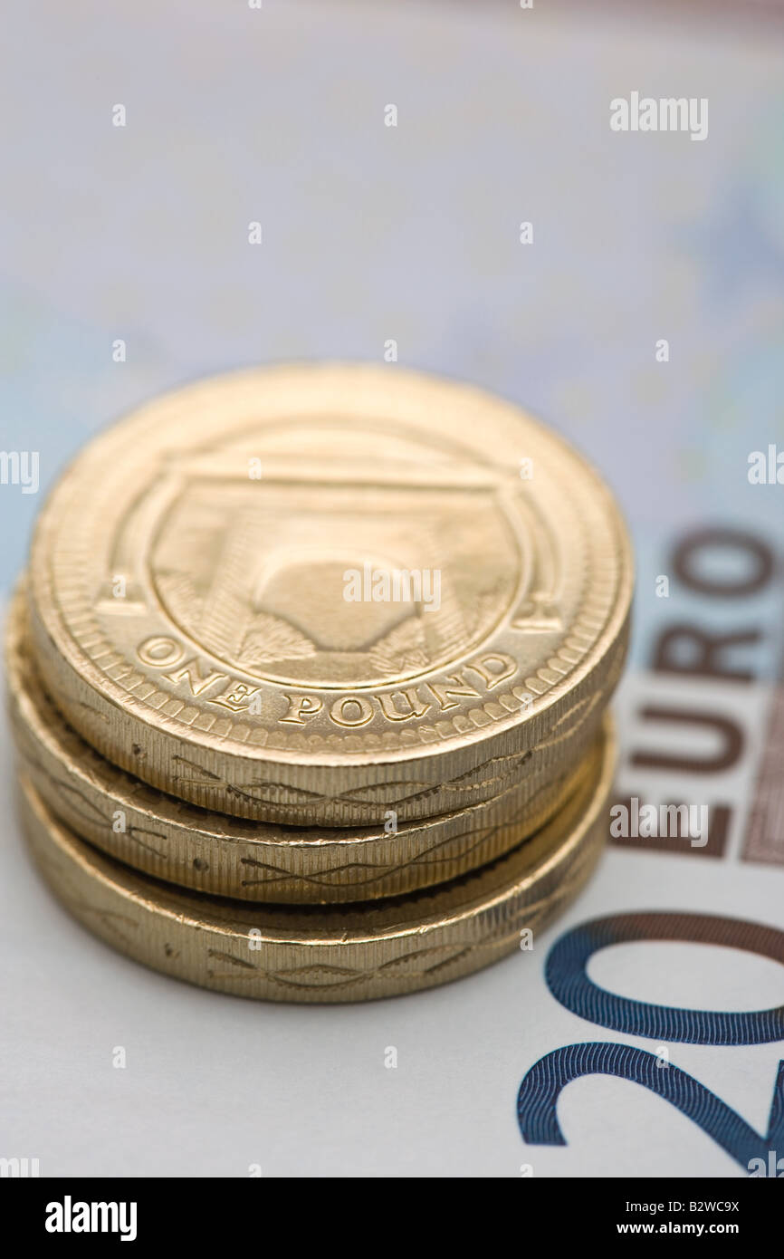 Pound coins on euro note Stock Photo - Alamy