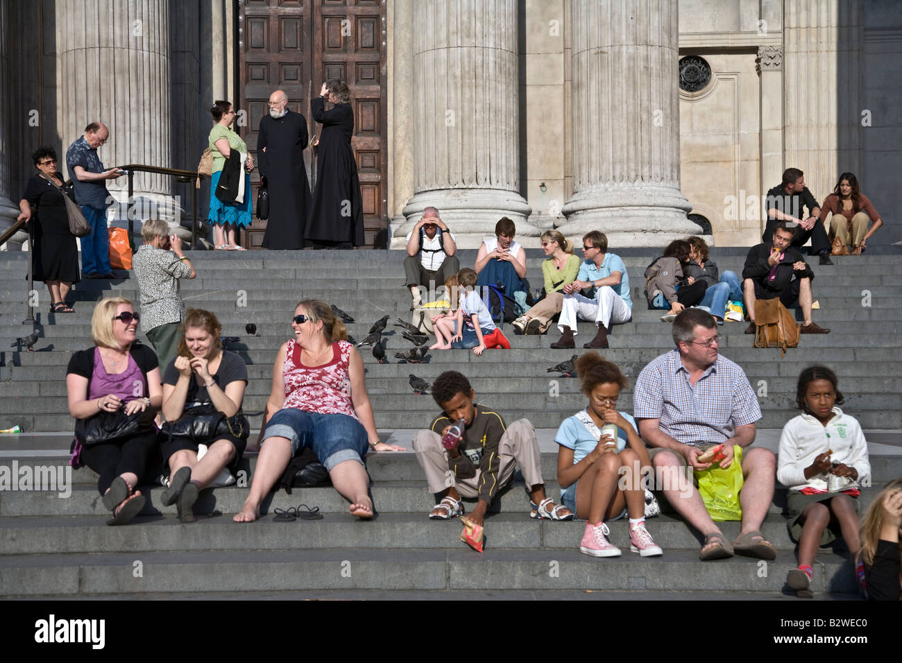 group of people sitting down outside st pauls cathedral in london Stock ...