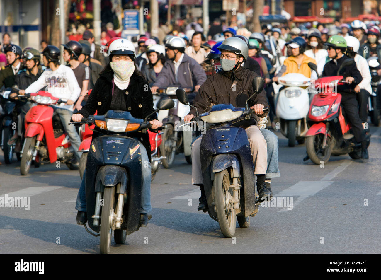 Motorcycles crowd streets of Hanoi Vietnam Stock Photo - Alamy