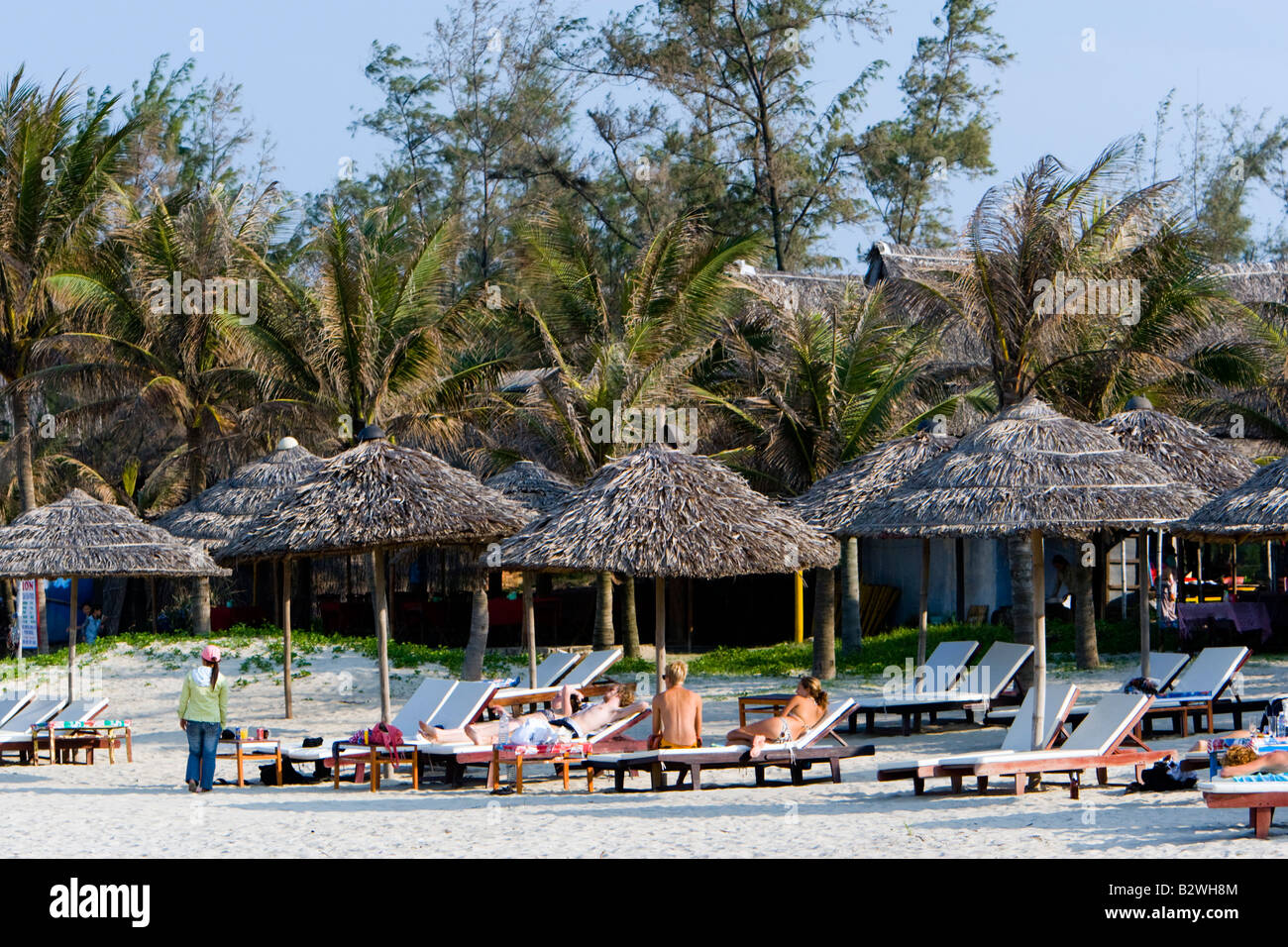 Palm thatch shades and sun beds Cua Dai beach Hoi An Vietnam Stock ...