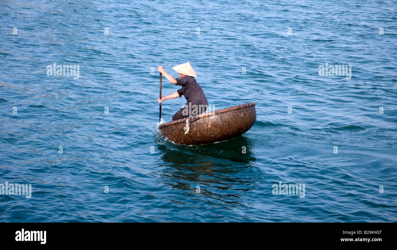 Conical hat woman paddles traditional circular woven coracle boat near ...