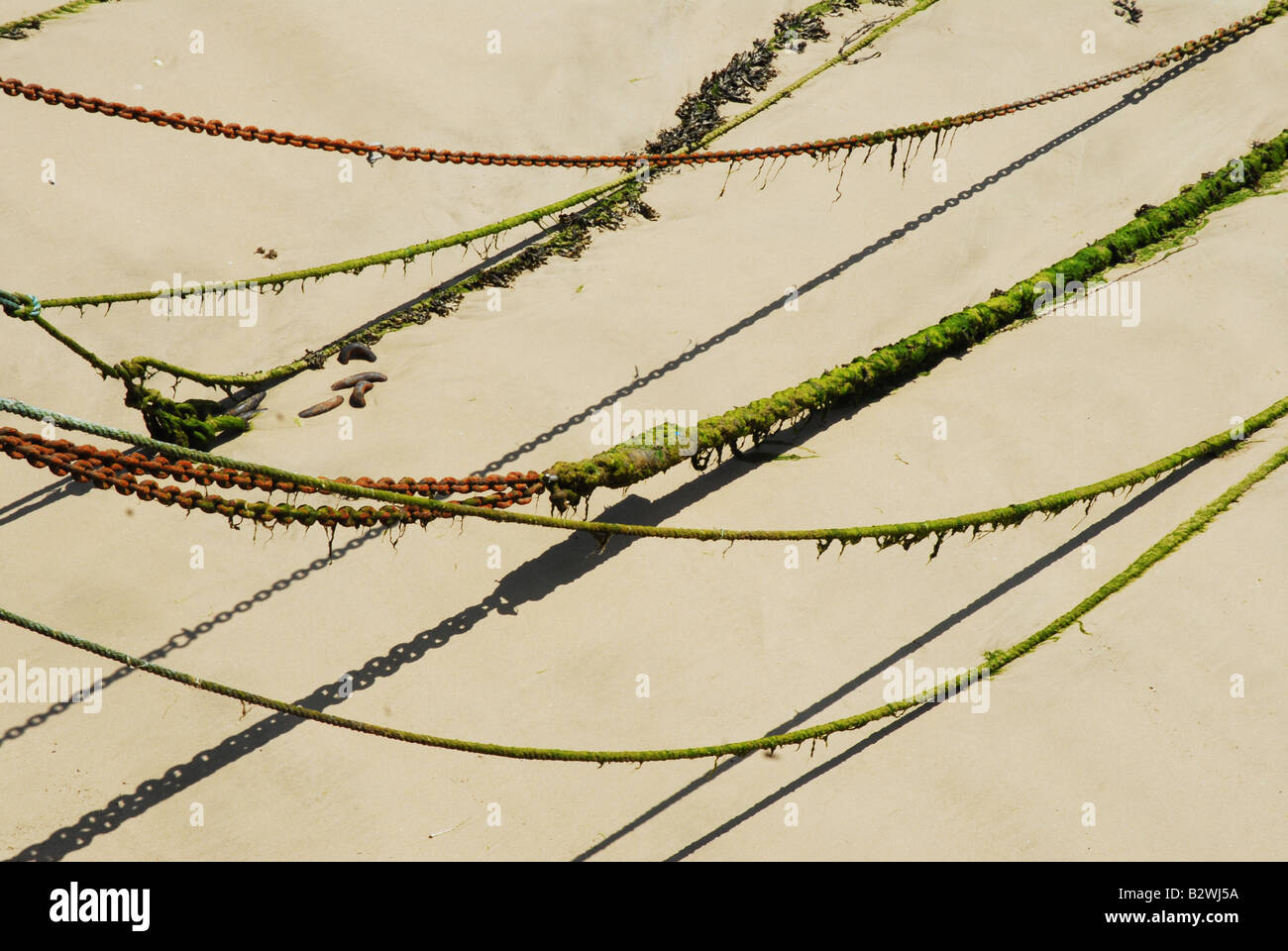 Abstract pattern of hanging chain and rope over sand Stock Photo - Alamy