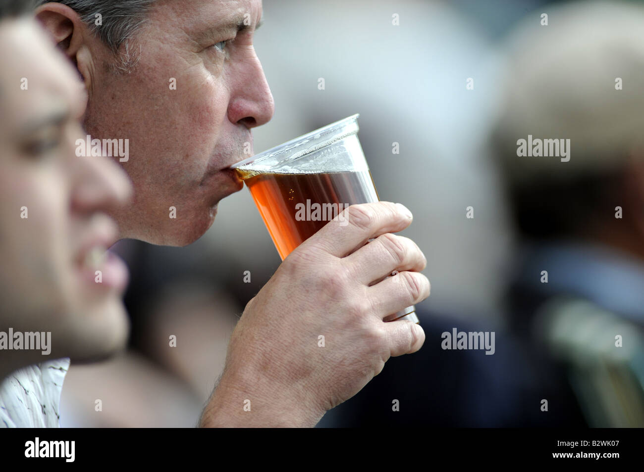 Man sips a pint of beer while watching cricket at the picturesque ...