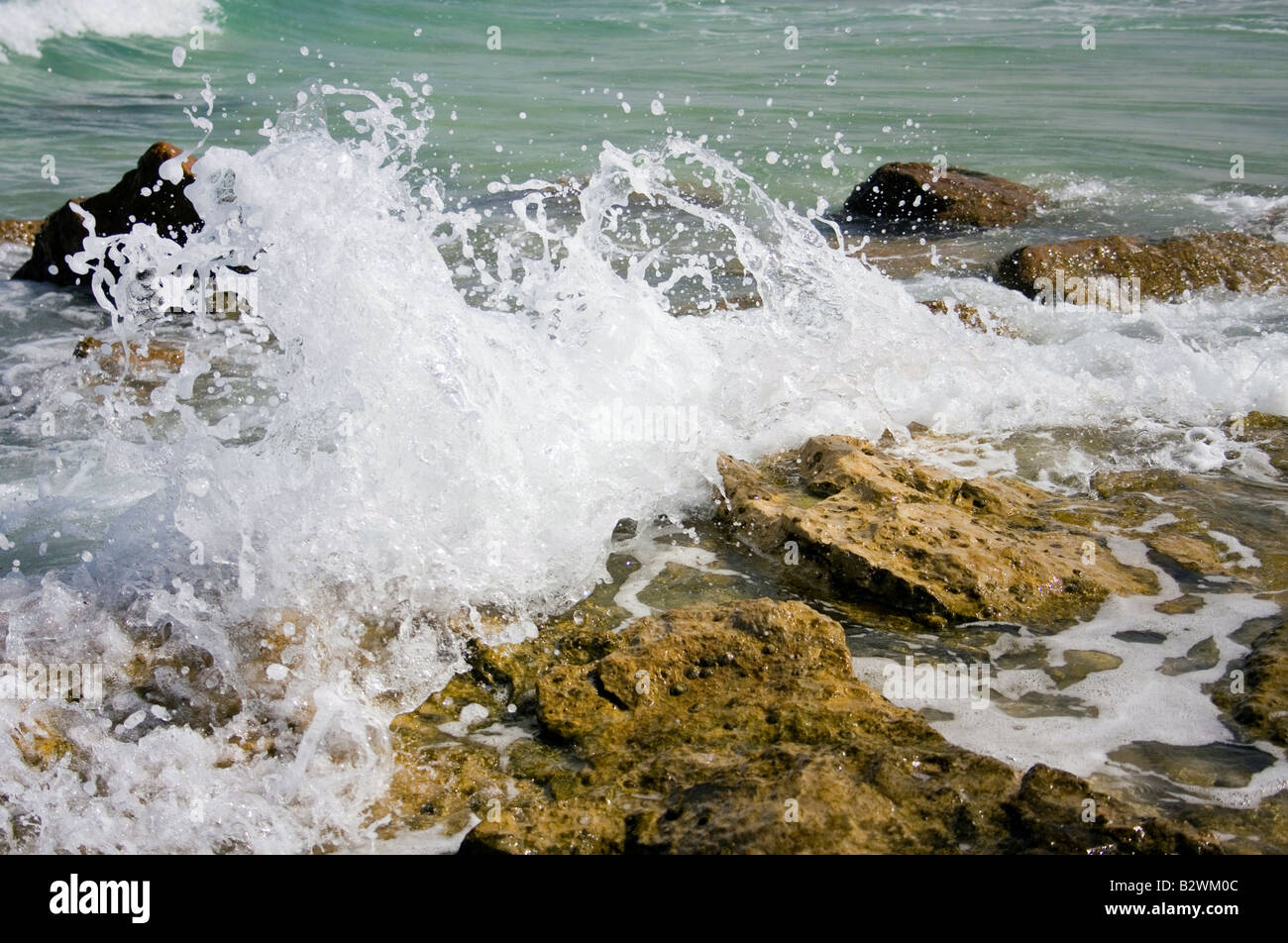 Splash of the waves against the rocks at sea Stock Photo - Alamy