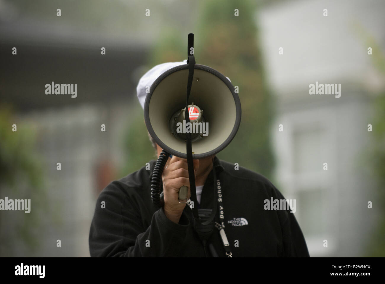 A man speaks into a megaphone Stock Photo - Alamy