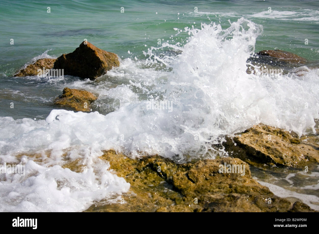 Splash of the waves against the rocks at sea Stock Photo - Alamy