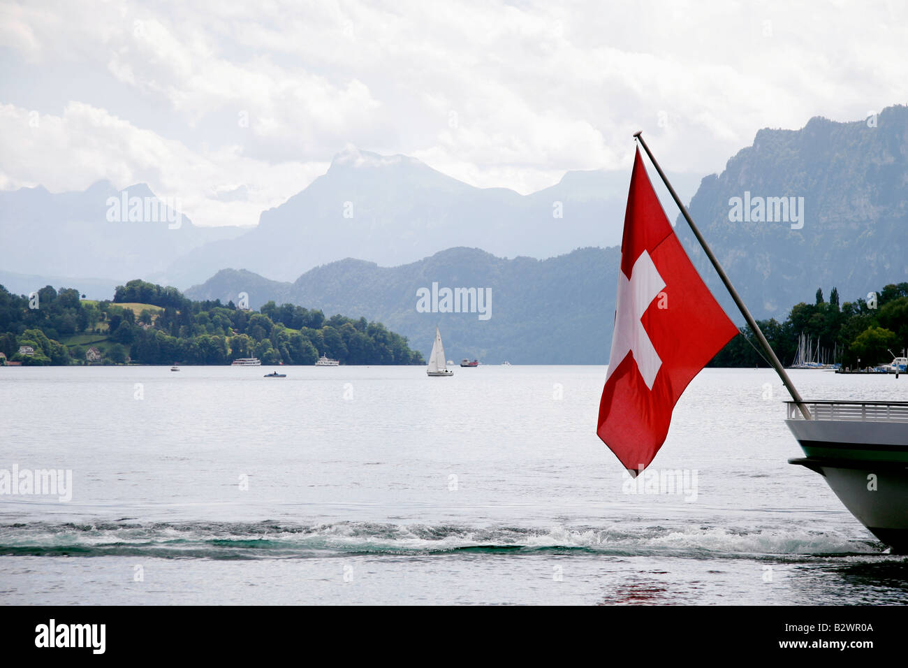 Swiss flag on the back of a passenger ferry on the Lake of Lucerne ...